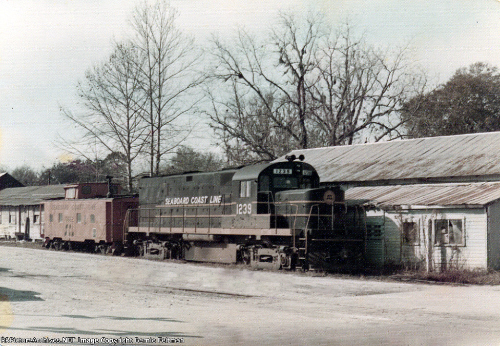 Seaboard Coast Line Alco C420 #1239 and caboose #0852 behind the depot